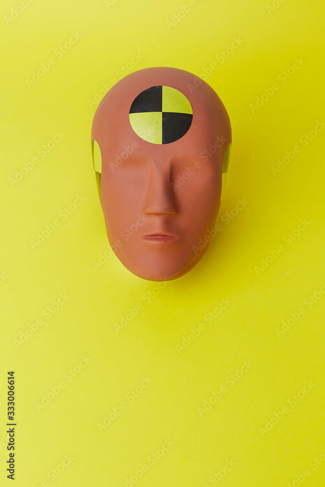 Crash test dummy head on yellow background Stock Photo | Adobe Stock
