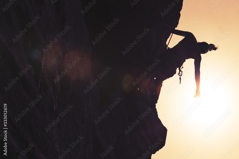 Rock climbing into the sun. Perfect for copy and text in the dark rock ...