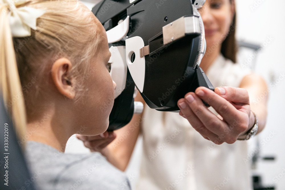 Eyewear: Tech Checks Prescription Of Young Girl With Phoropter Stock Photo | Adobe Stock