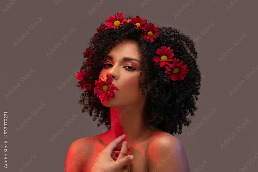 Beauty afro girl with flowers in hair. Stock Photo | Adobe Stock