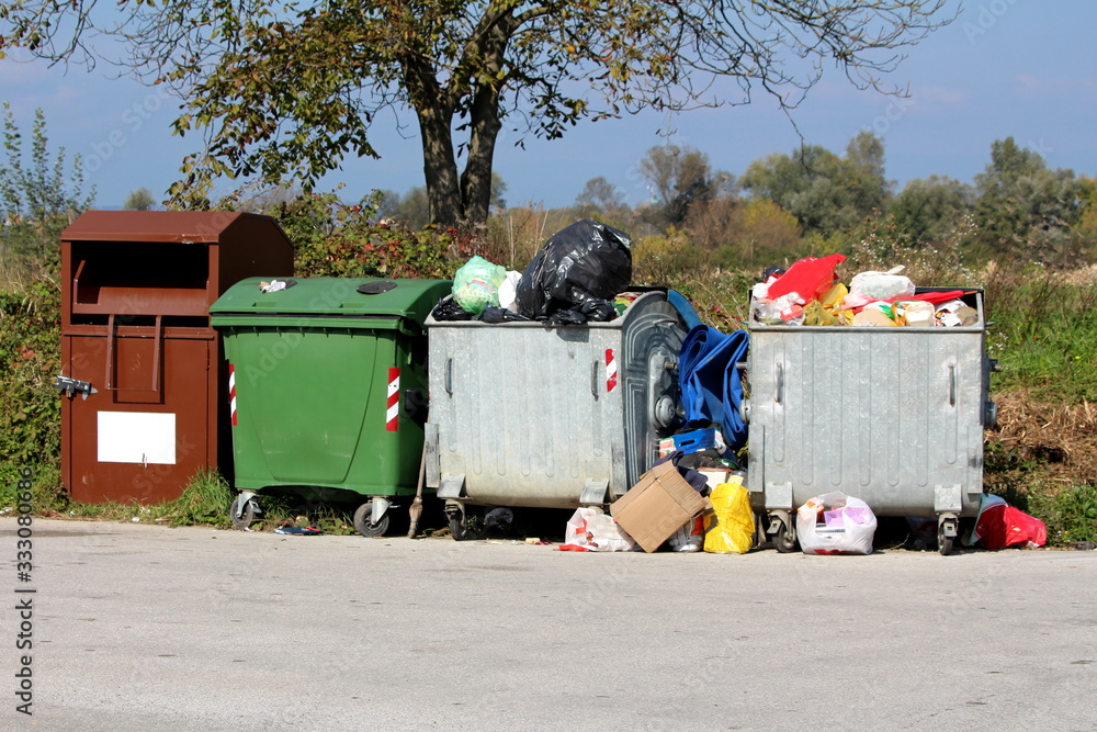 Various large metal and plastic trash containers for ecologically ...