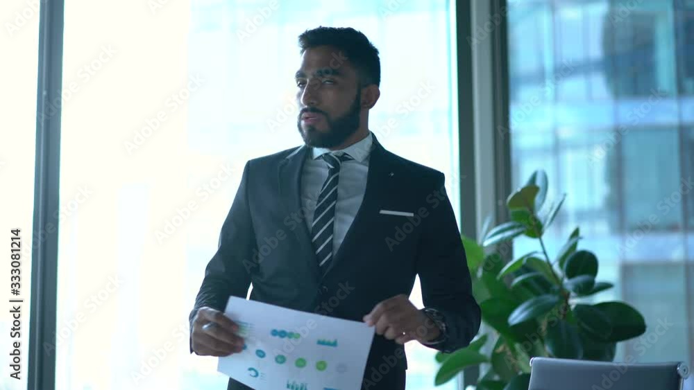 Experienced formally dressed corporate director holding paper report ...