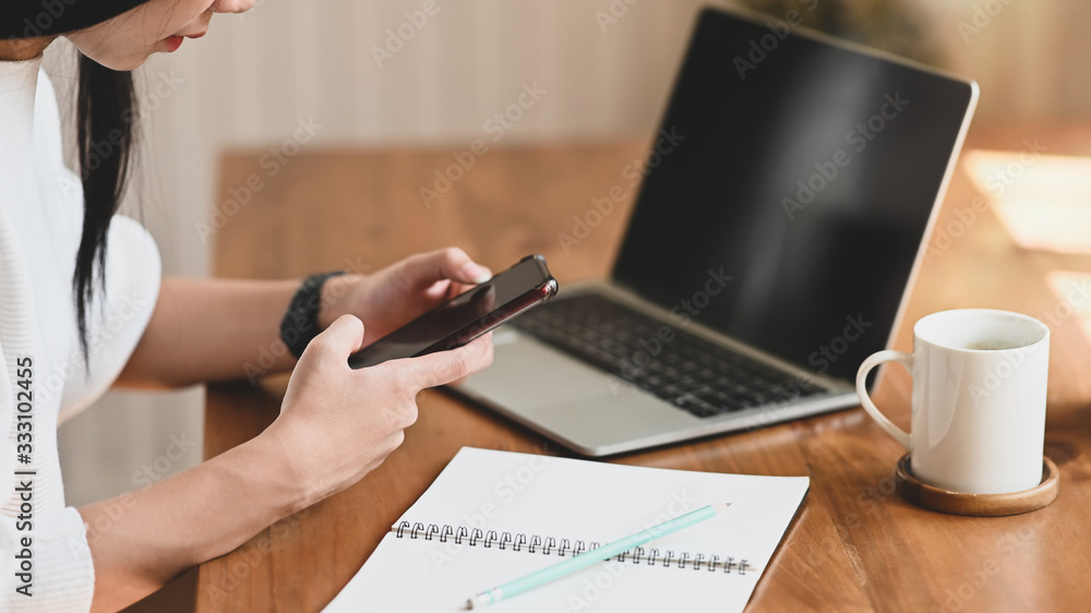 Cropped image of beautiful woman working as secretary holding/using a ...