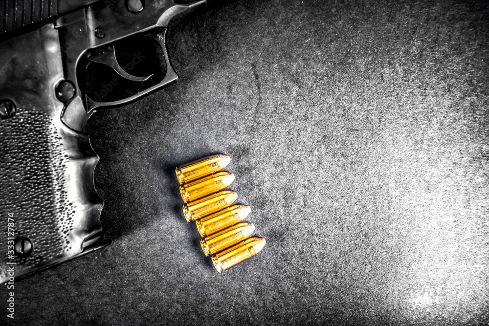 Bullets and handcuffs. Close-up of 9mm pistol. Gun and weapon with ...