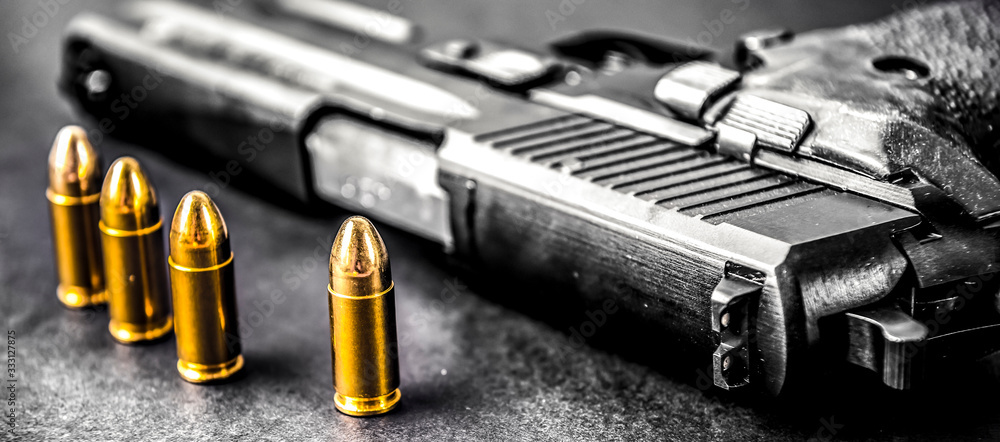 Bullets and handcuffs. Close-up of 9mm pistol. Gun and weapon with ...