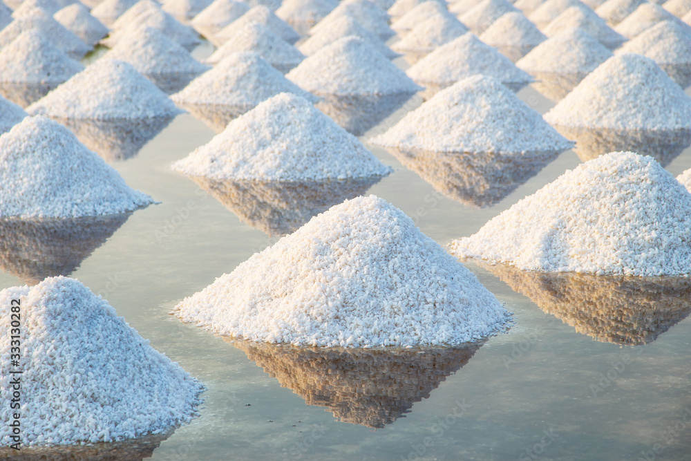 Foto de Sea salt pile pyramid ready for harvest in salt farm at sunrise ...