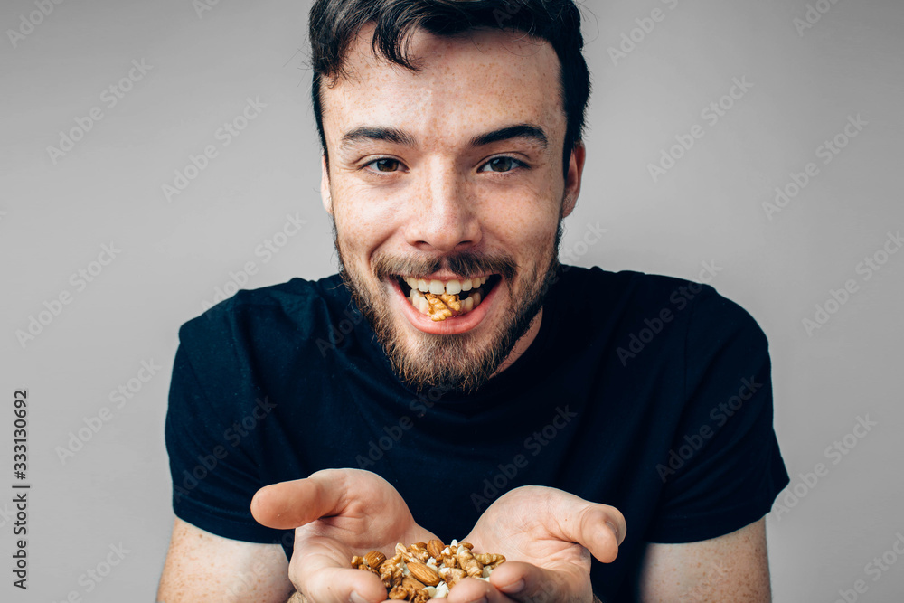 Young man isolated over background. Guy in black clothes hold ...
