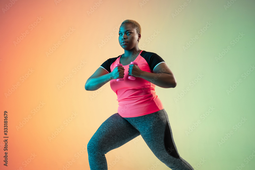 Young african-american plus size female model's training on gradient ...
