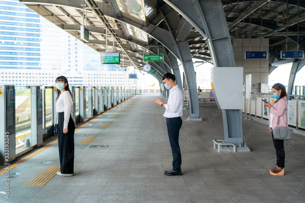 Three Asian people wearing mask standing distance of 1 meter from other ...
