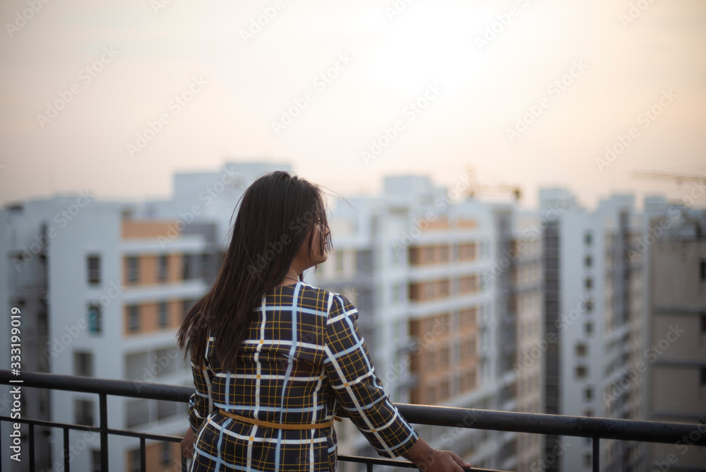 Back side of an young brunette Indian Bengali brunette plus size woman ...