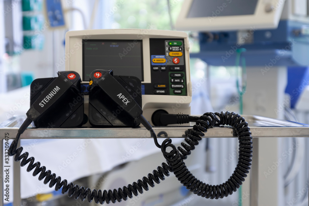 Defibrillator, on background medical ventilator in ICU in hospital, a ...