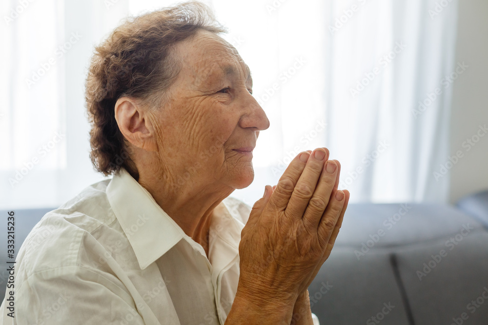 Faithful old senior grandmother pray with hope faith holding hands ...