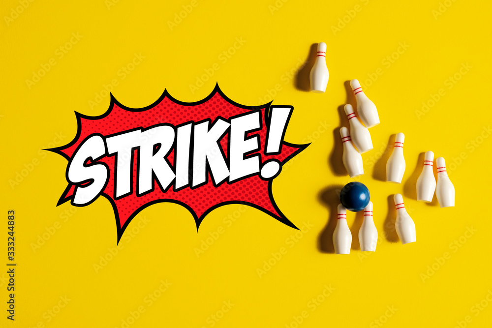 Knocked over bowling pins and bowling ball after rolling a strike on a ...