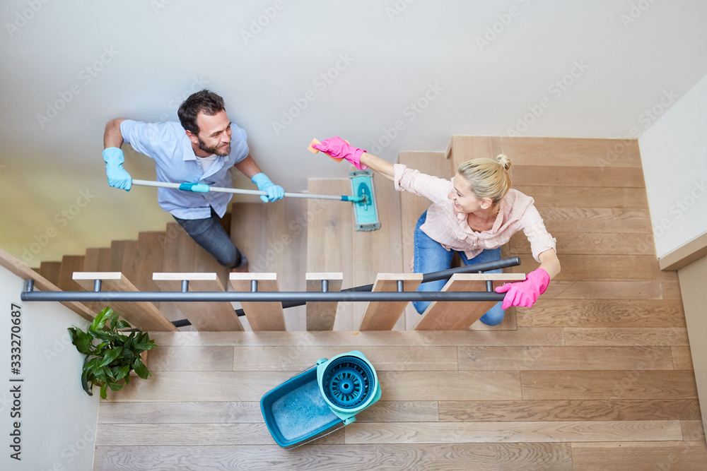 Couple has fun at the stairwell and hallway cleaning Stock Photo ...