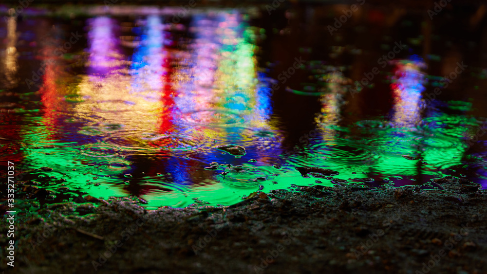 Colorful colors reflect in puddle when it rains Stock Photo | Adobe Stock