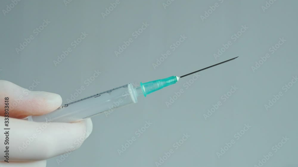 Hypodermic Needle syringe. closeup medic hands in white sterile ...
