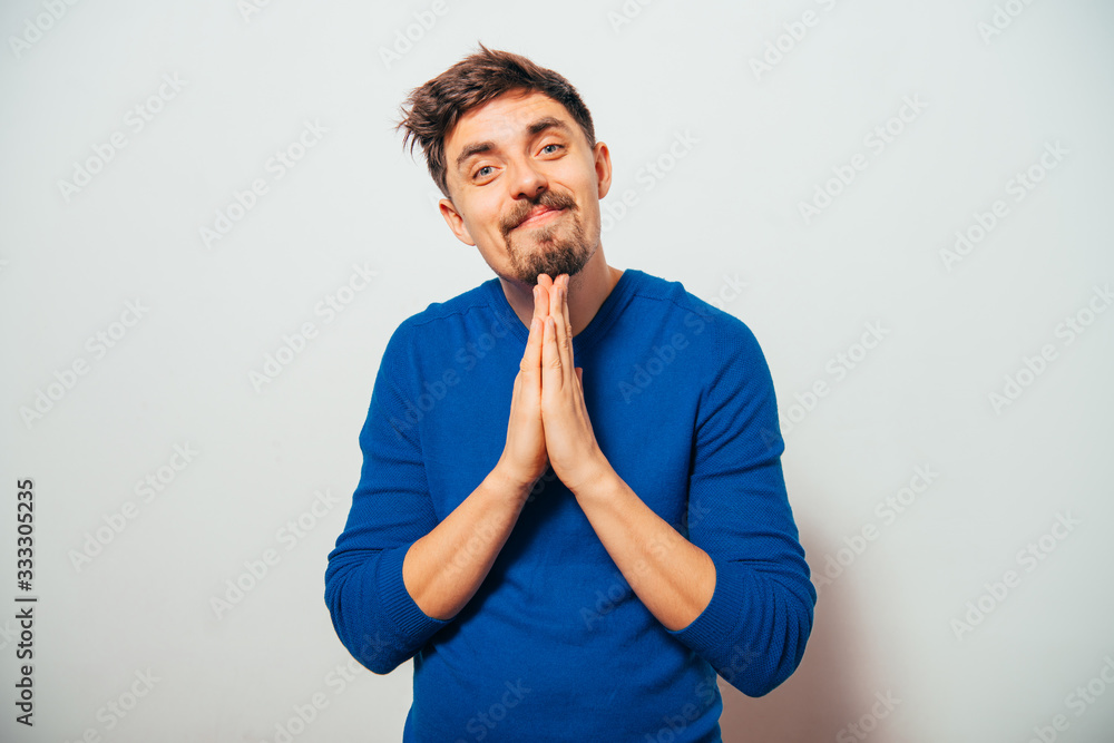 man requests. Closeup portrait of young man showing clasped hands ...