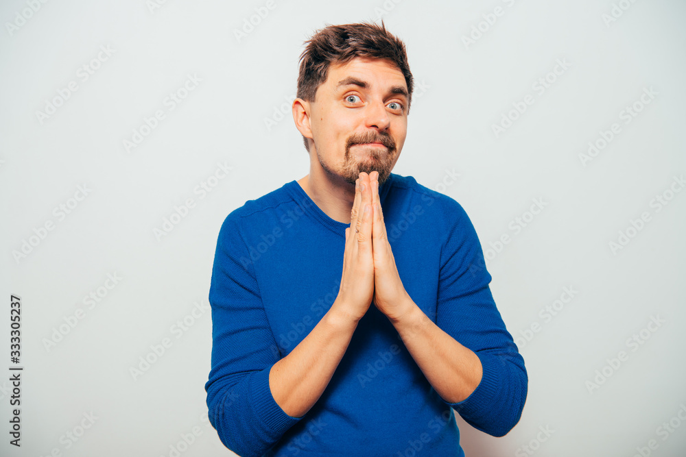 man requests. Closeup portrait of young man showing clasped hands ...