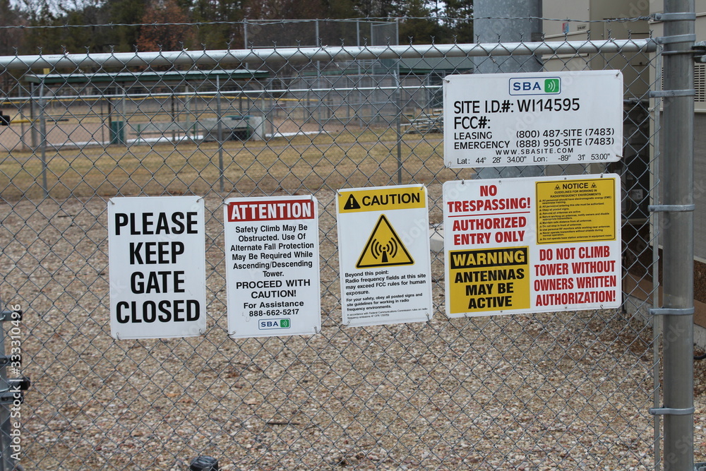 warning signs by a radio tower Stock Photo | Adobe Stock