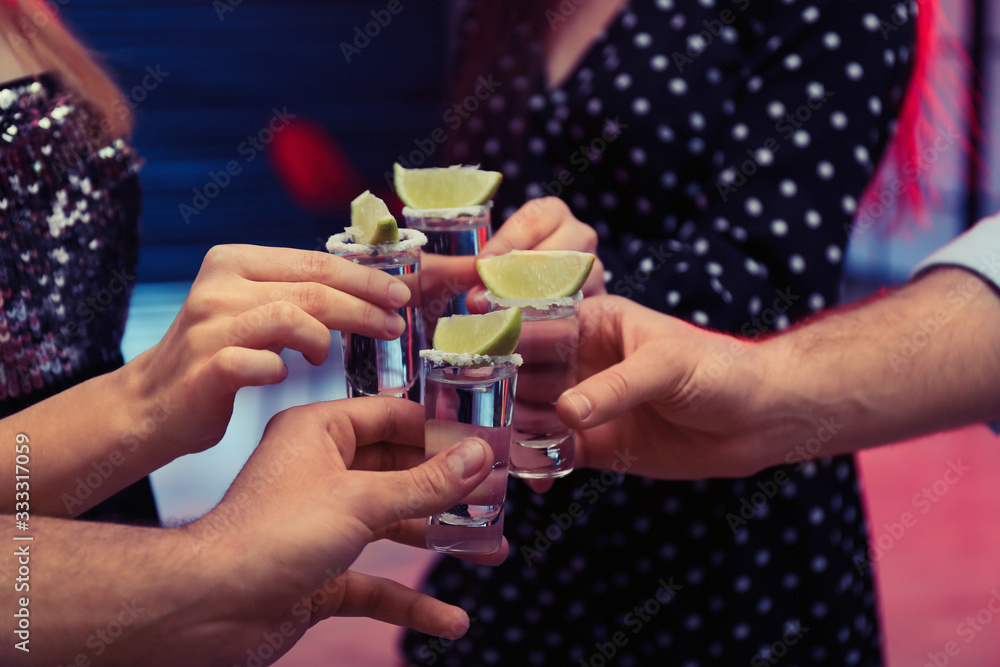 Young people toasting with Mexican Tequila shots in bar, closeup Stock ...