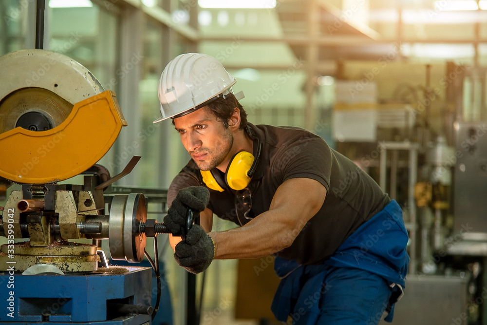 Mechanic wearing uniform safety in factory working machine lathe metal ...