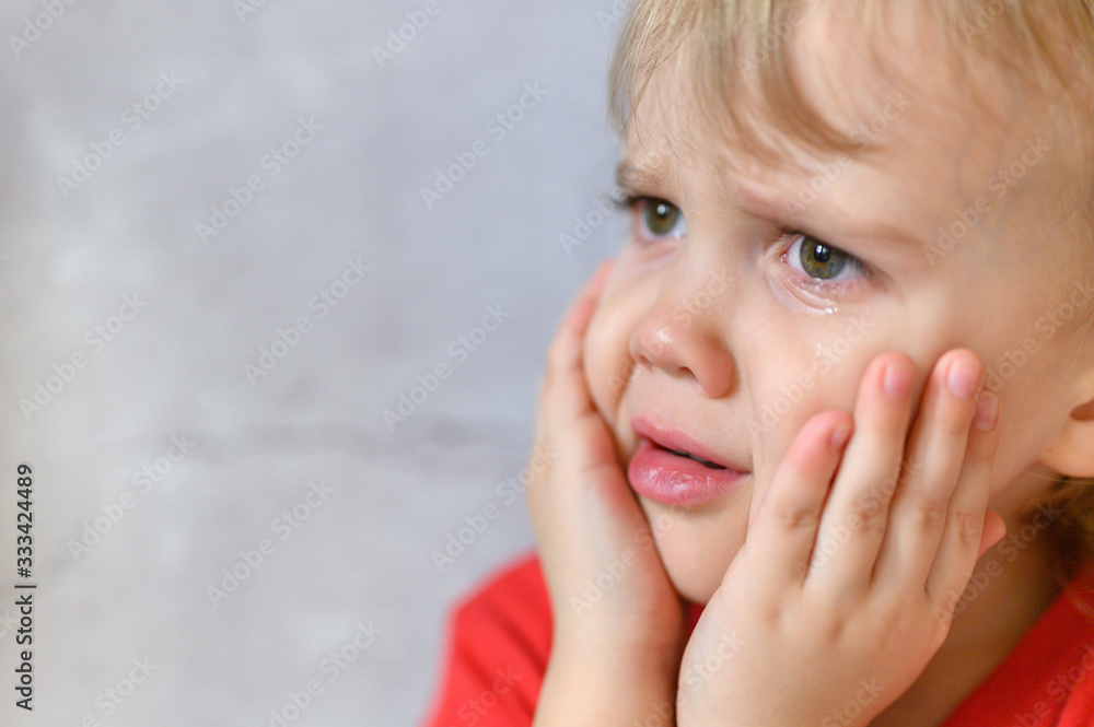 kid crying. the face of a cute little upset four year old baby boy in ...