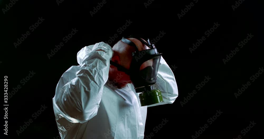 Environmental disaster a post-apocalyptic survivor in a gas mask on a ...