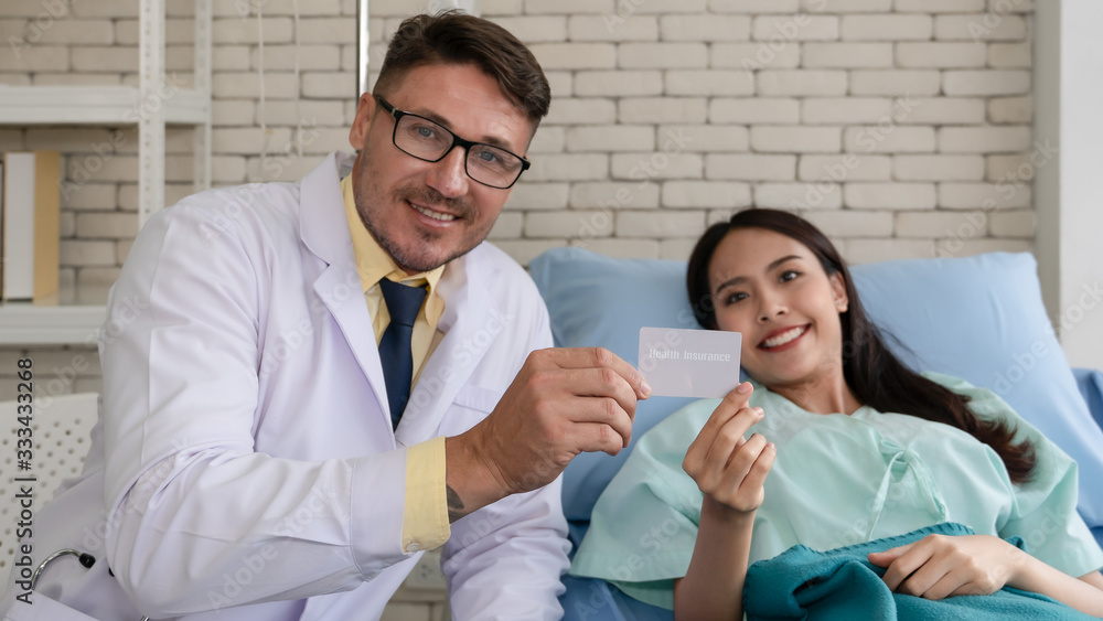 health insurance card in hands of doctor and patient that having thumb ...