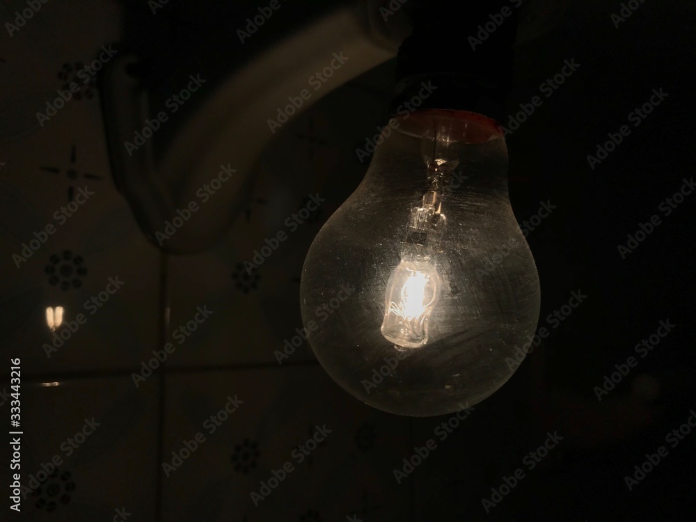 image of a lit light bulb showing its filaments Stock Photo | Adobe Stock