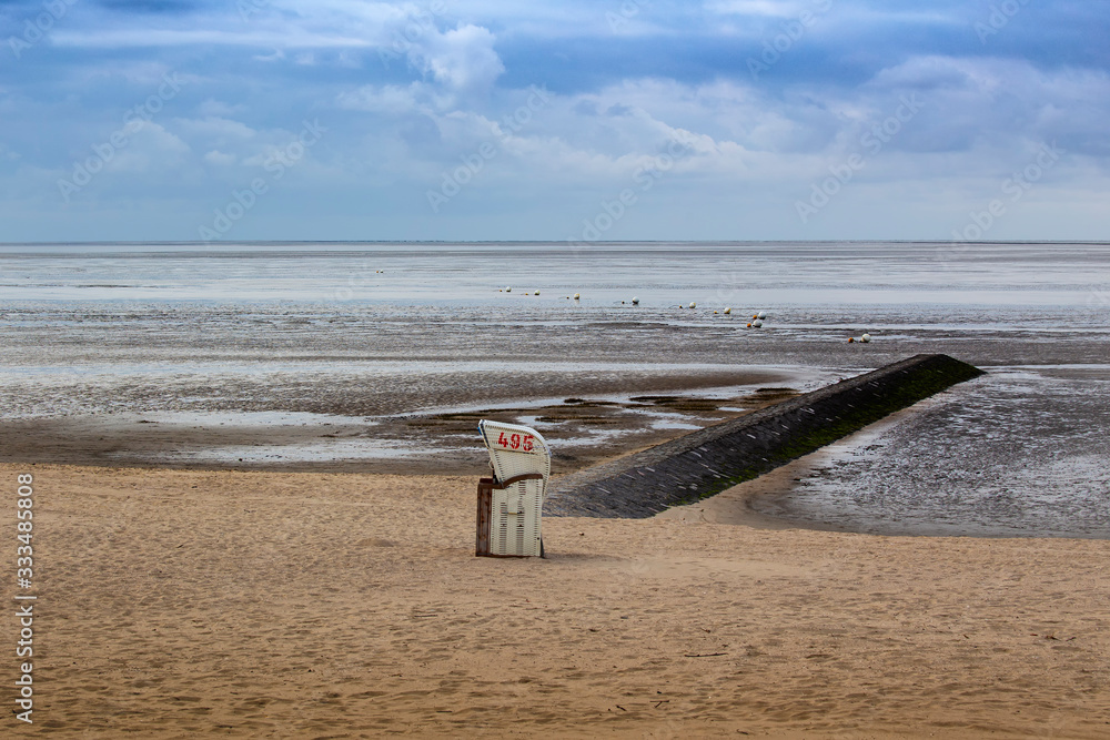 Sandy beach on the North Sea in Cuxhaven in Germany. The background is ...