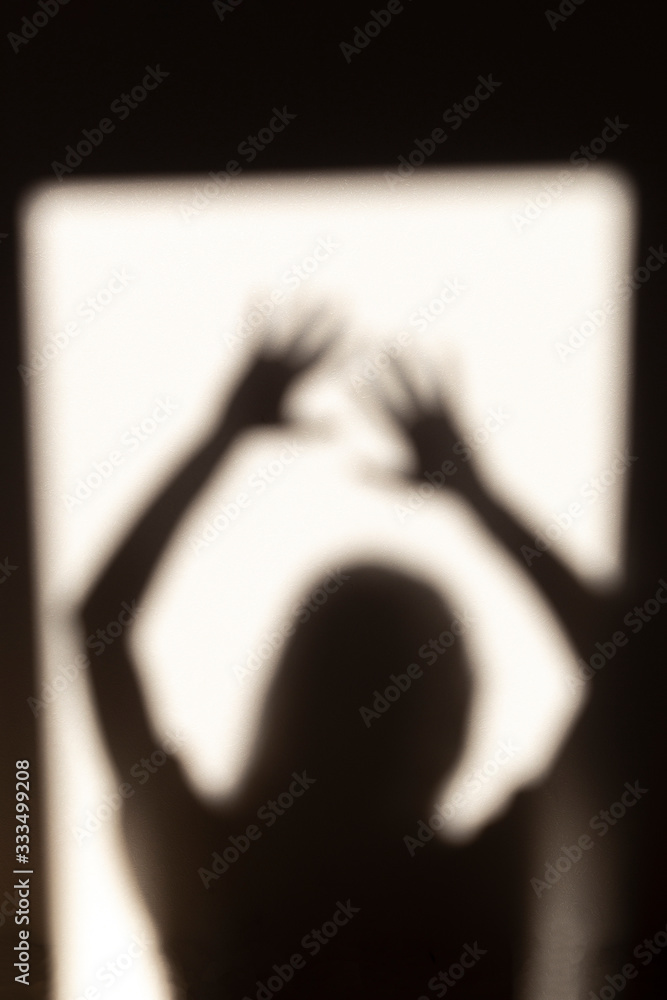 Shadow of girl in the window. Scary silhouette of locked up girl as ...
