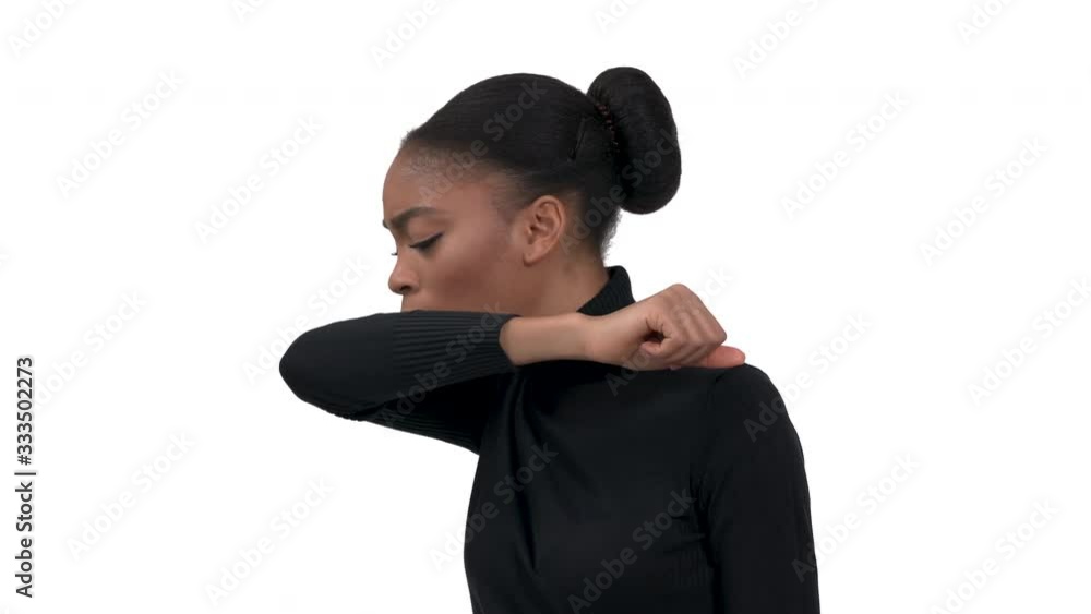 Side view of a young african woman in a black roll-neck polo raises her ...
