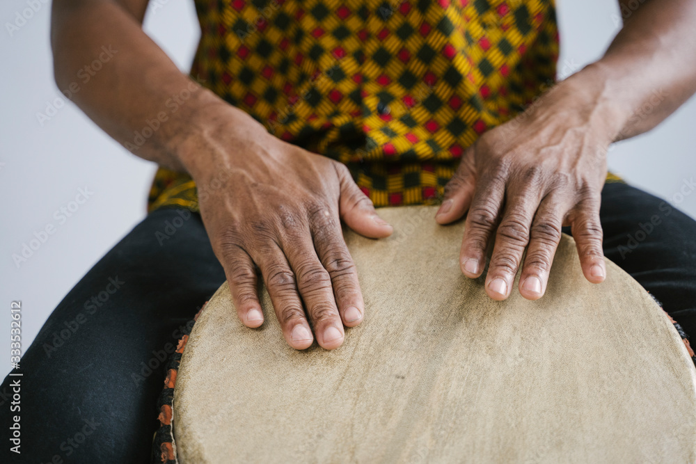 Detail of african american man musician playing traditional drums at ...