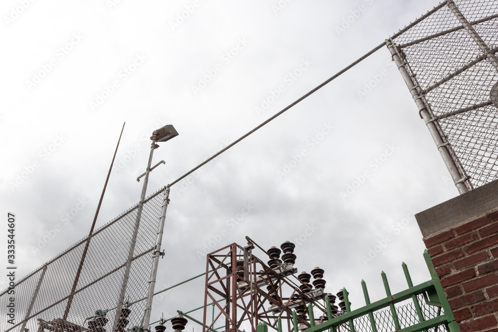 Extreme upward view into an electrical power substation, trusses ...