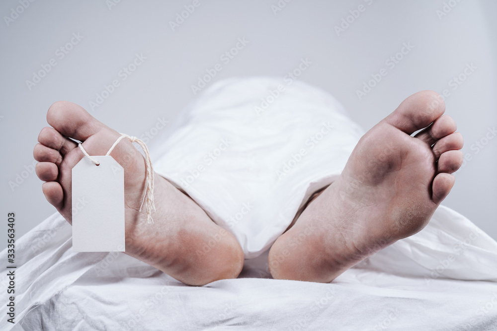 Feet of a dead body, with an identification tag - blank sign attached ...