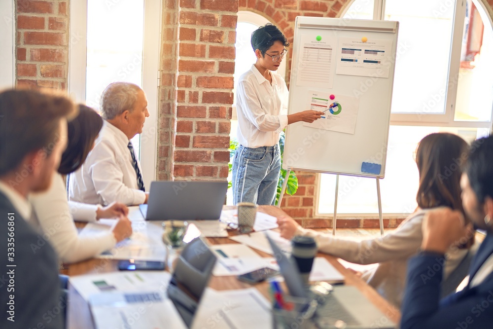 Group of business workers working together in a meeting. One of them ...