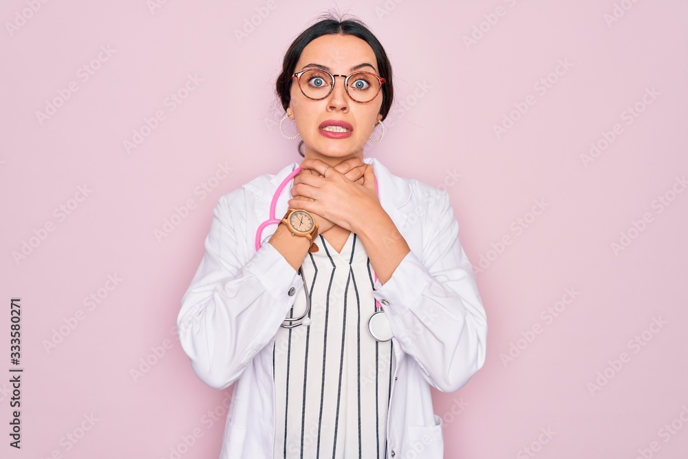 Beautiful doctor woman with blue eyes wearing coat and stethoscope over ...