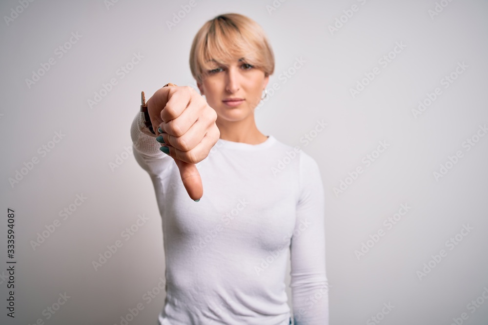 Young beautiful blonde woman with modern short hair hairstyle standing ...