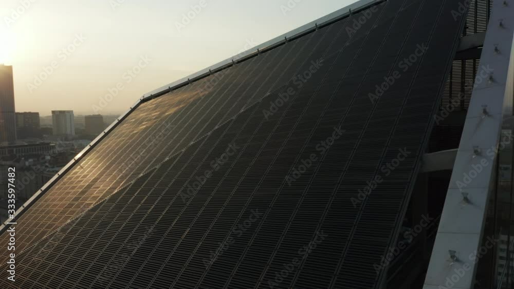 Drone shot on the roof of a skyscraper building with solar panels at ...