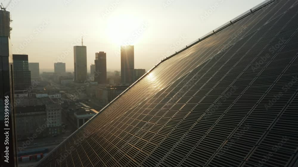 Drone shot on the roof of a skyscraper building with solar panels at ...