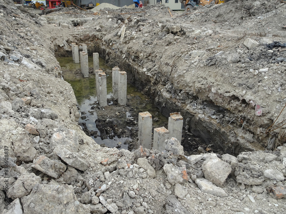 Square precast concrete pile at the construction site. Driven to soil ...