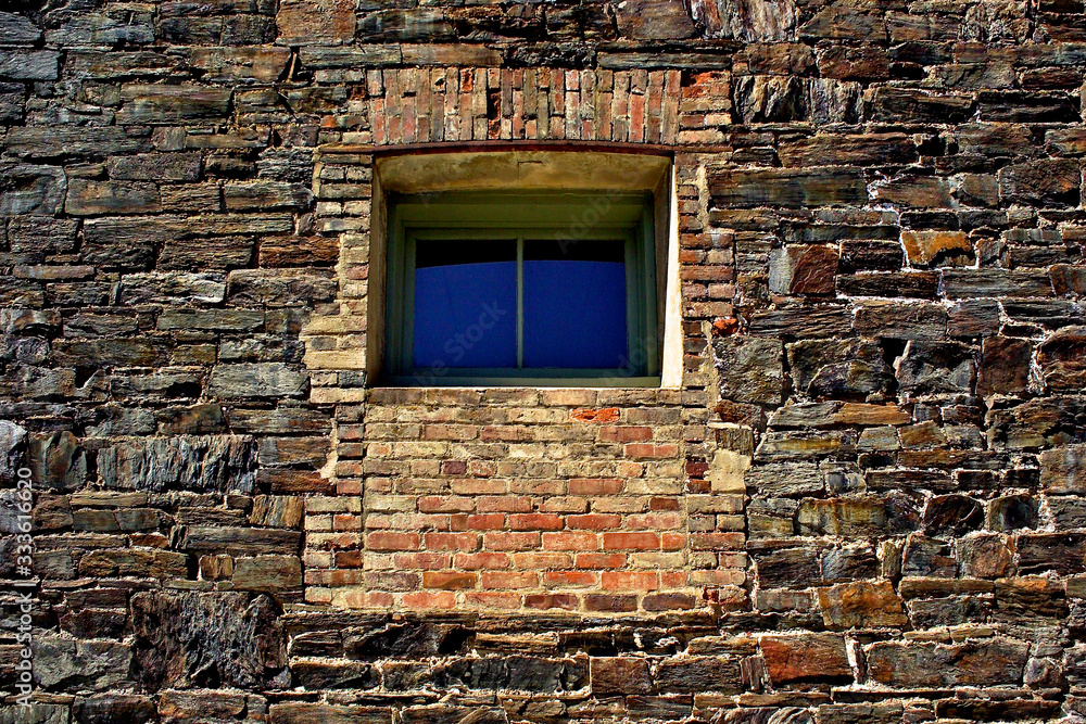 Fieldstone wall with brick inset window Stock Photo | Adobe Stock