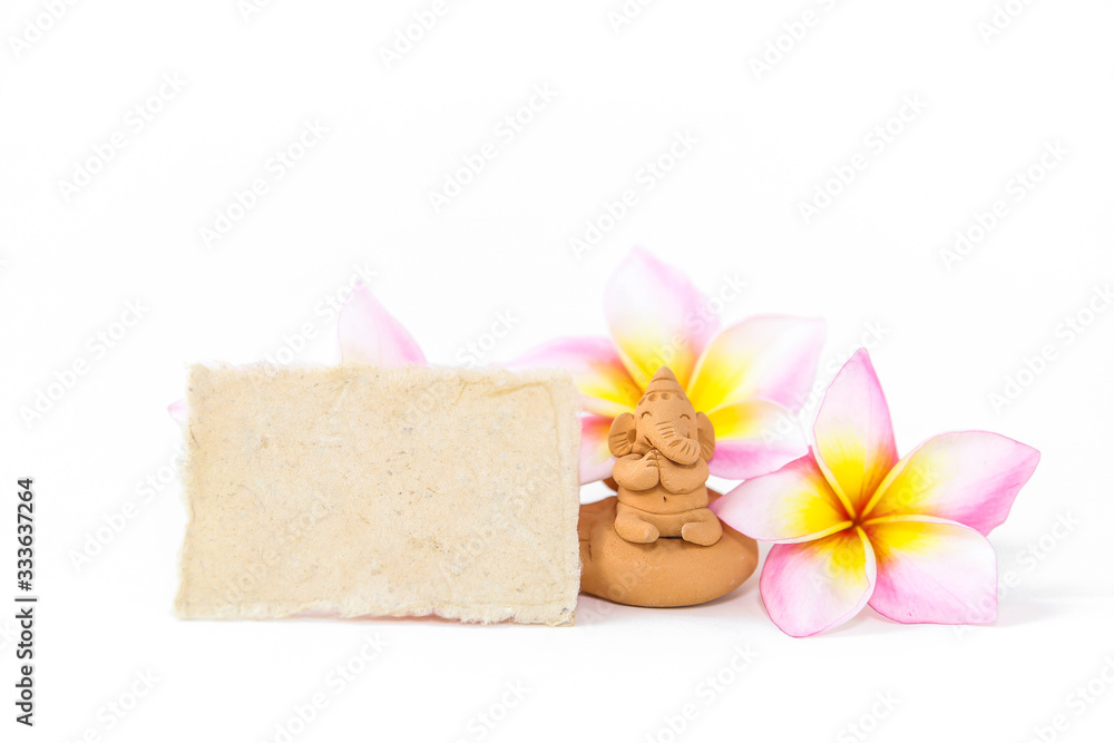 Praying elephant clay sculpture with blank paper card and plumeria ...
