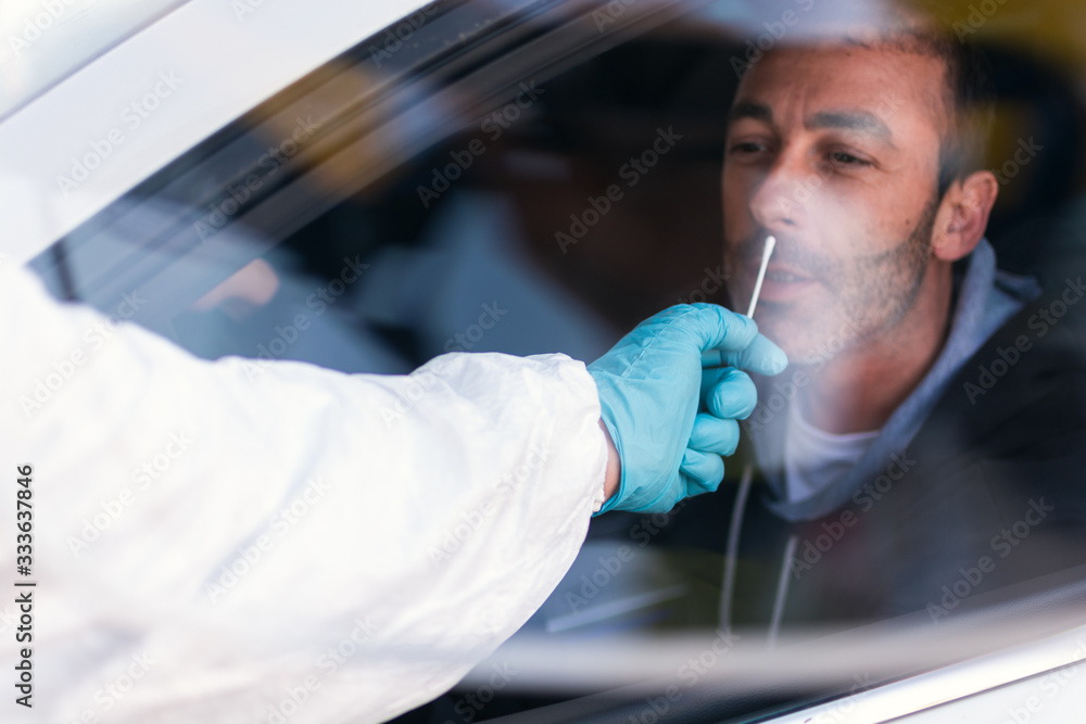 Man wearing an NBC personal protective equipment (ppe) suit, gloves ...