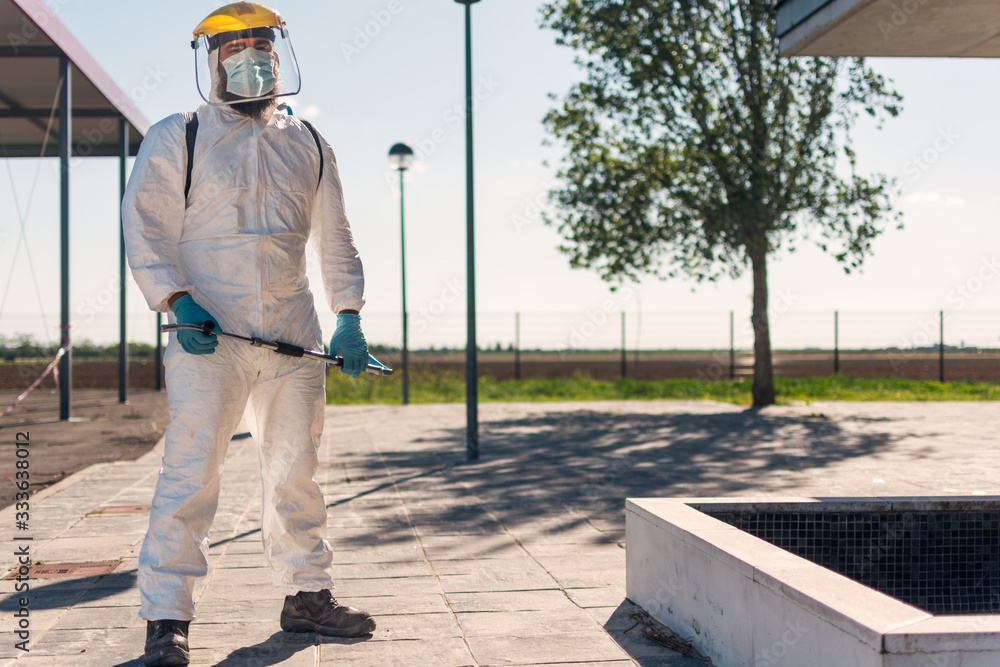 Man wearing an NBC personal protective equipment (ppe) suit, gloves ...