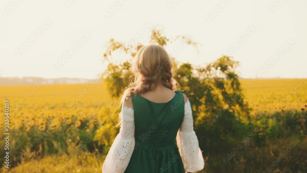 Beautiful young cute charming rural girl goes to sunflower field ...