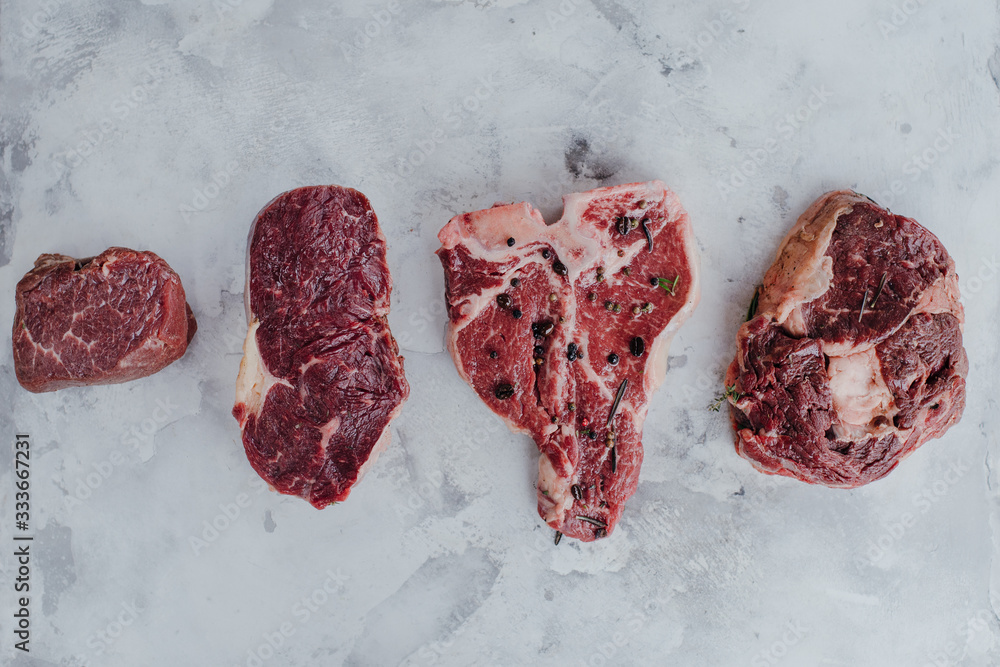 Different types of raw meat for steaks, T-bone, ribeye, fillet, sirloin ...
