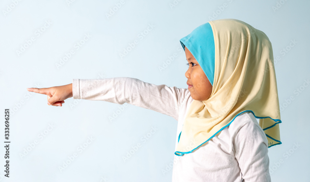 Muslim girl wearing hijab pointing to the left, isolated portrait ...
