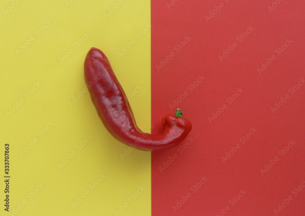 Trendy Ugly organic red pepper a colored background. Funny, unnormal ...
