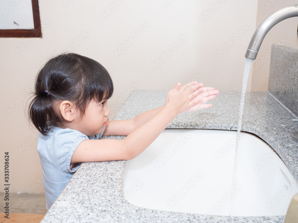 Fotografia do Stock: Asian little cute girl washing hands with soap at ...